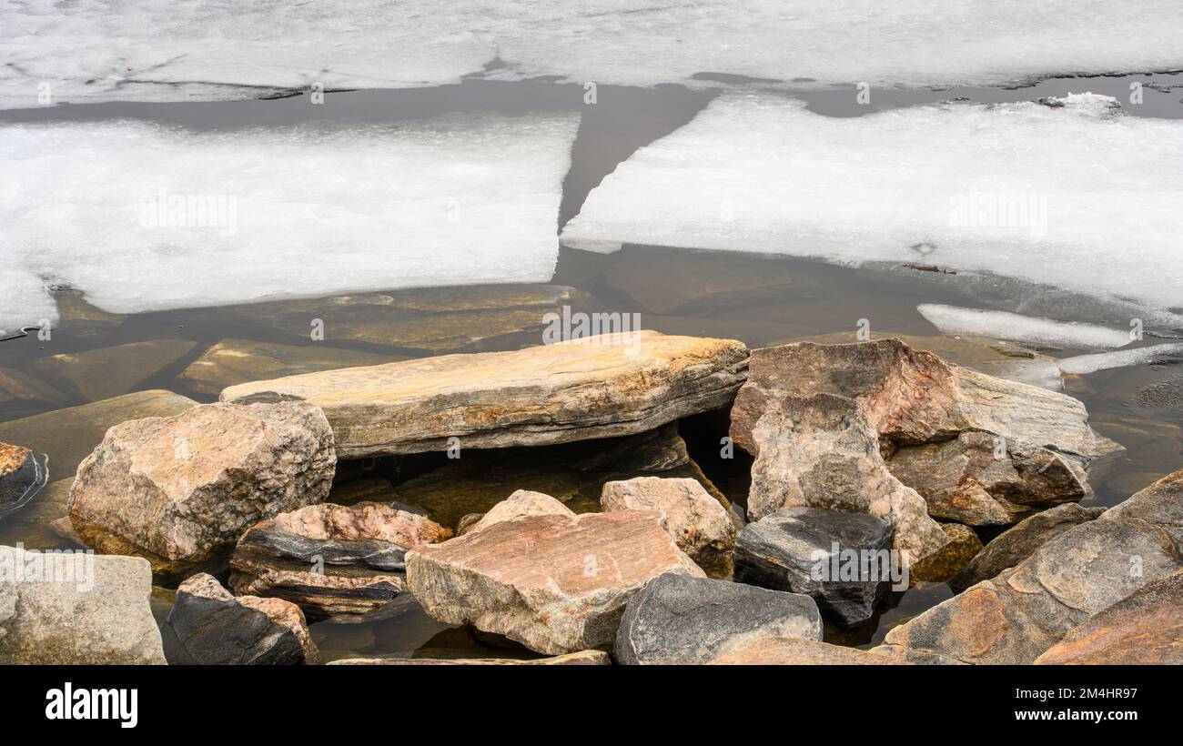 Melting ice, shoreline granite rock on Georgian Bay in early spring ...