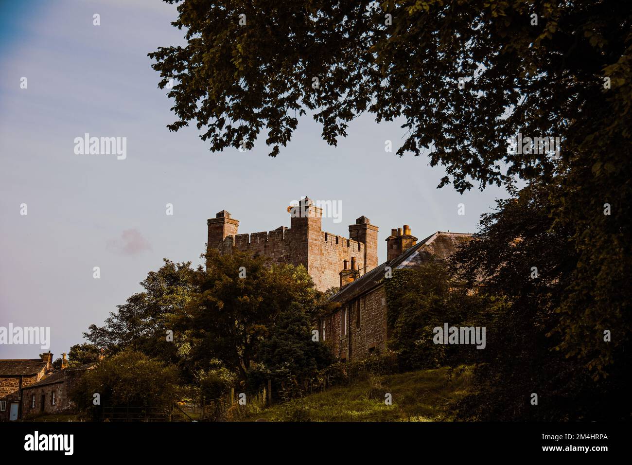 A beautiful view of an old English Castle through the green trees Stock ...