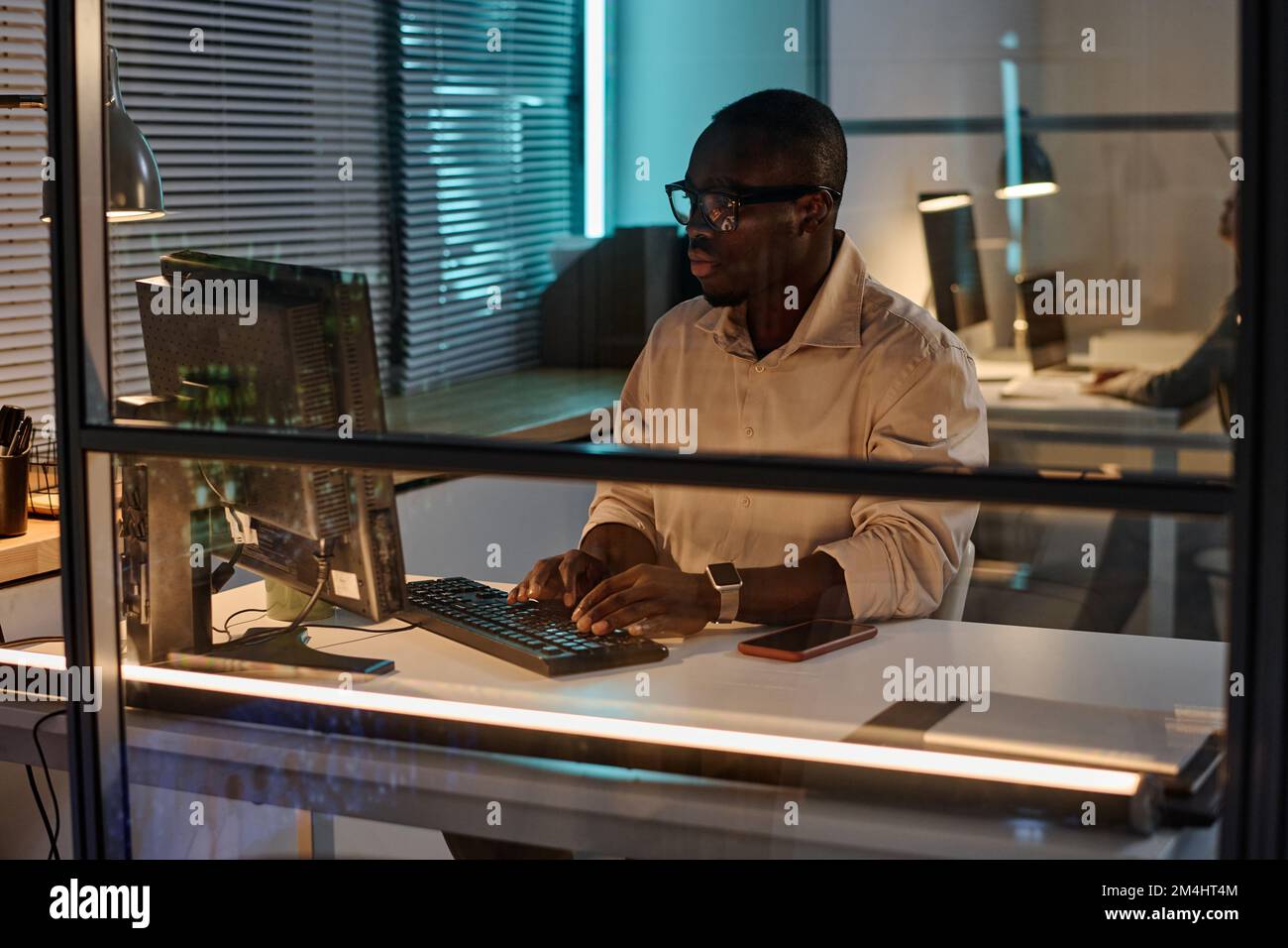 African American businessman concentrating on his work on computer ...