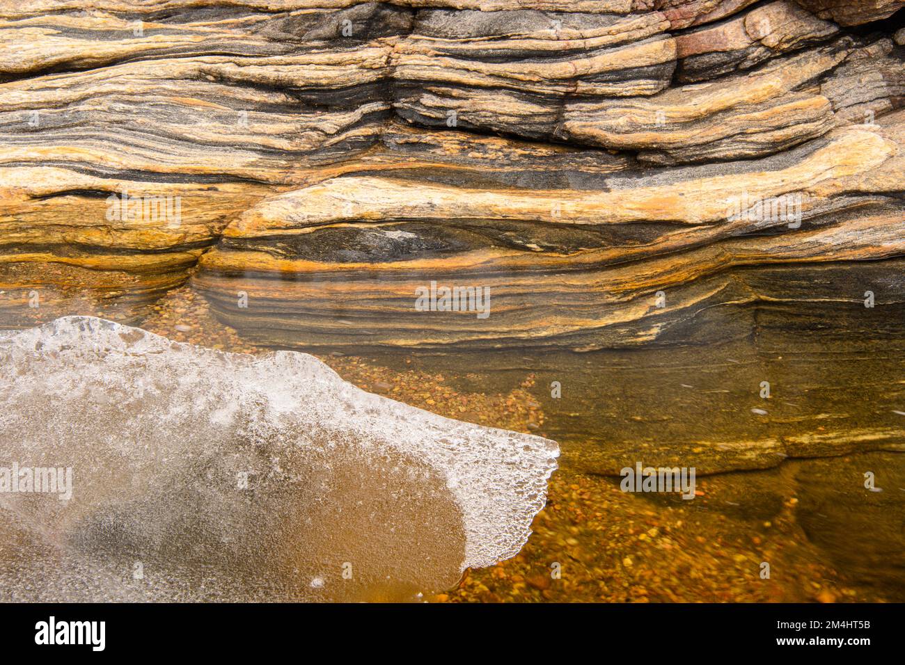 Melting ice, shoreline granite rock on Georgian Bay in early spring ...