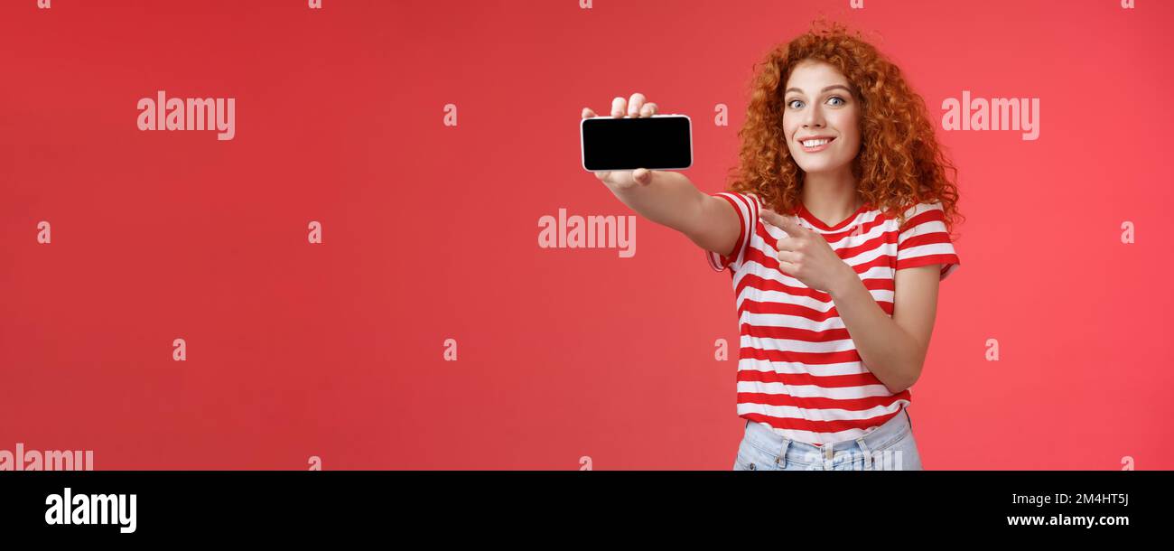 Excited happy good-looking redhead curly female show horizontal ...