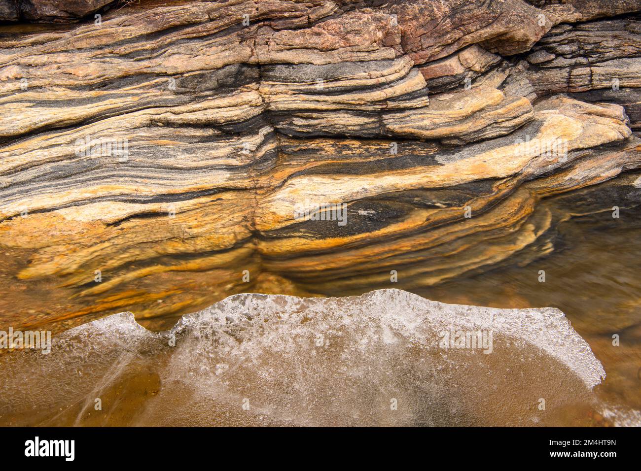Melting ice, shoreline granite rock on Georgian Bay in early spring ...