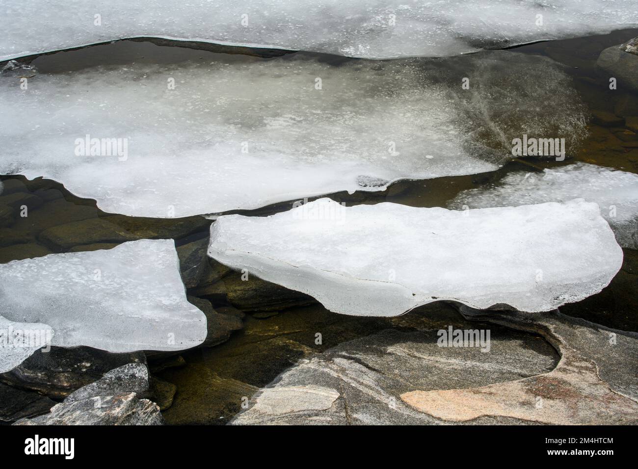 Melting ice, shoreline granite rock on Georgian Bay in early spring ...