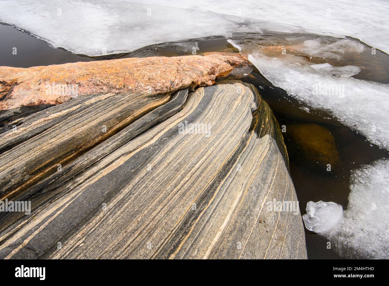 Melting ice, shoreline granite rock on Georgian Bay in early spring ...