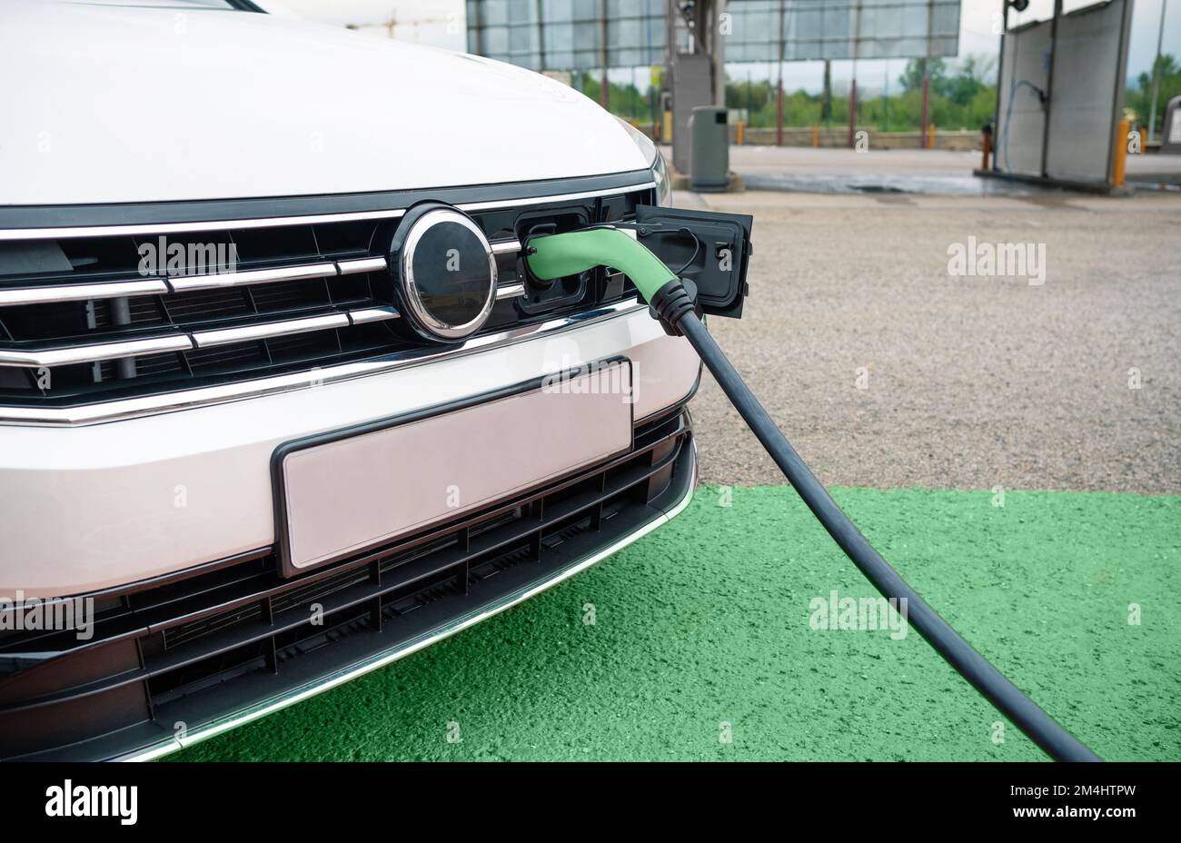 Socket plugged into electric car Stock Photo - Alamy