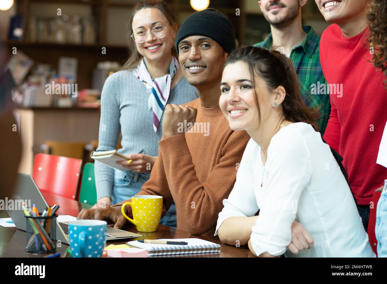 A group of people working together as a team on a project in a co ...