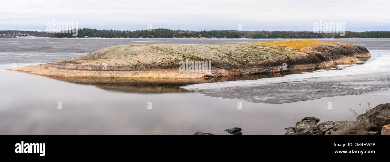 A small rock island in Georgian Bay, melting ice in early spring, Parry ...