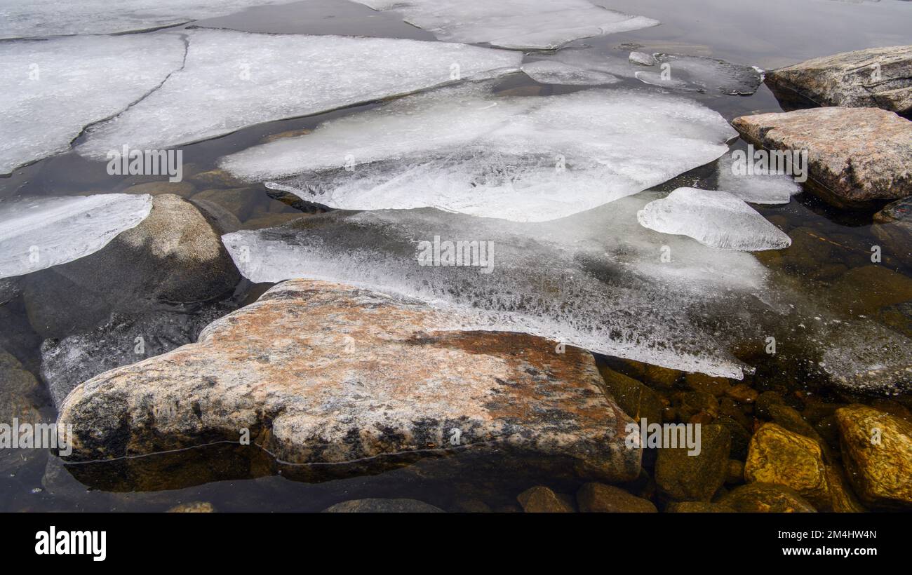 Melting ice, shoreline granite rock on Georgian Bay in early spring ...