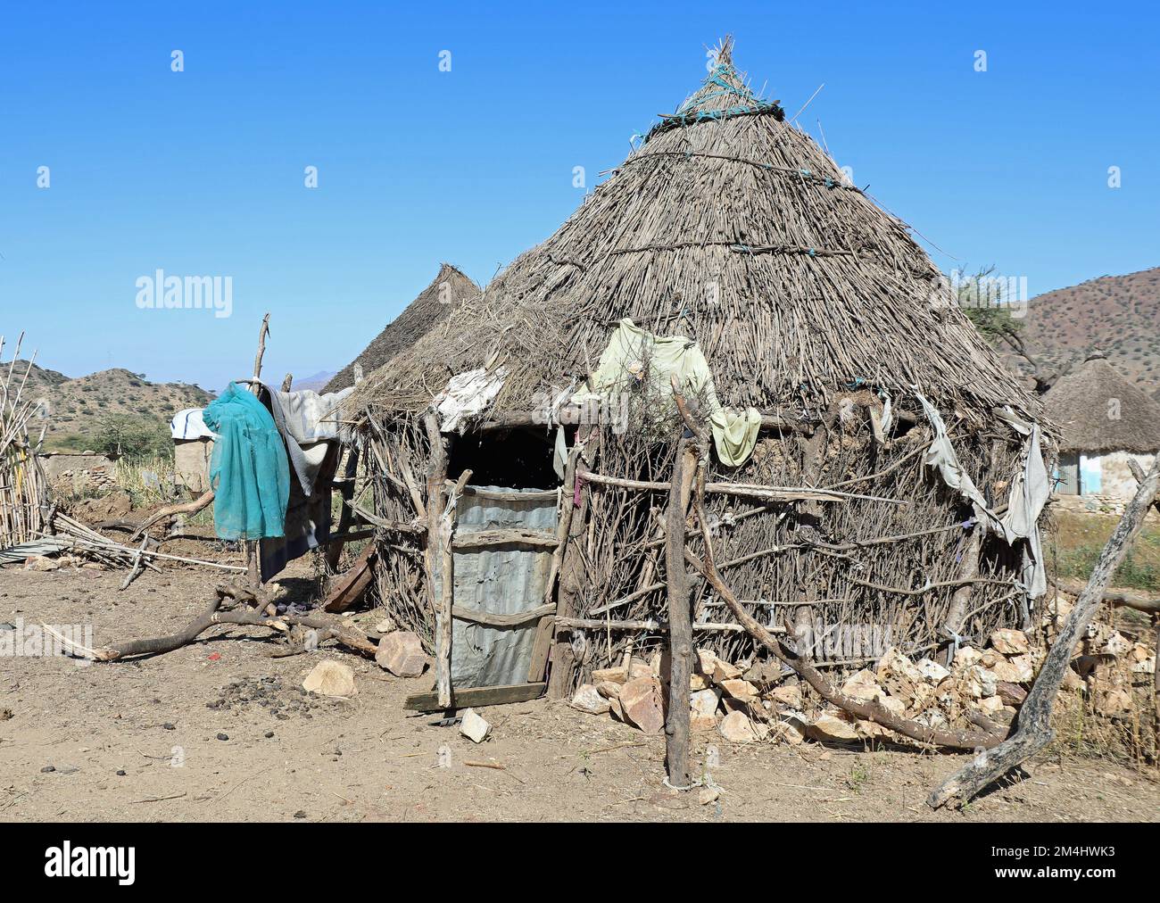 Insecticide treated mosquito net hung up outside a house] made of ...