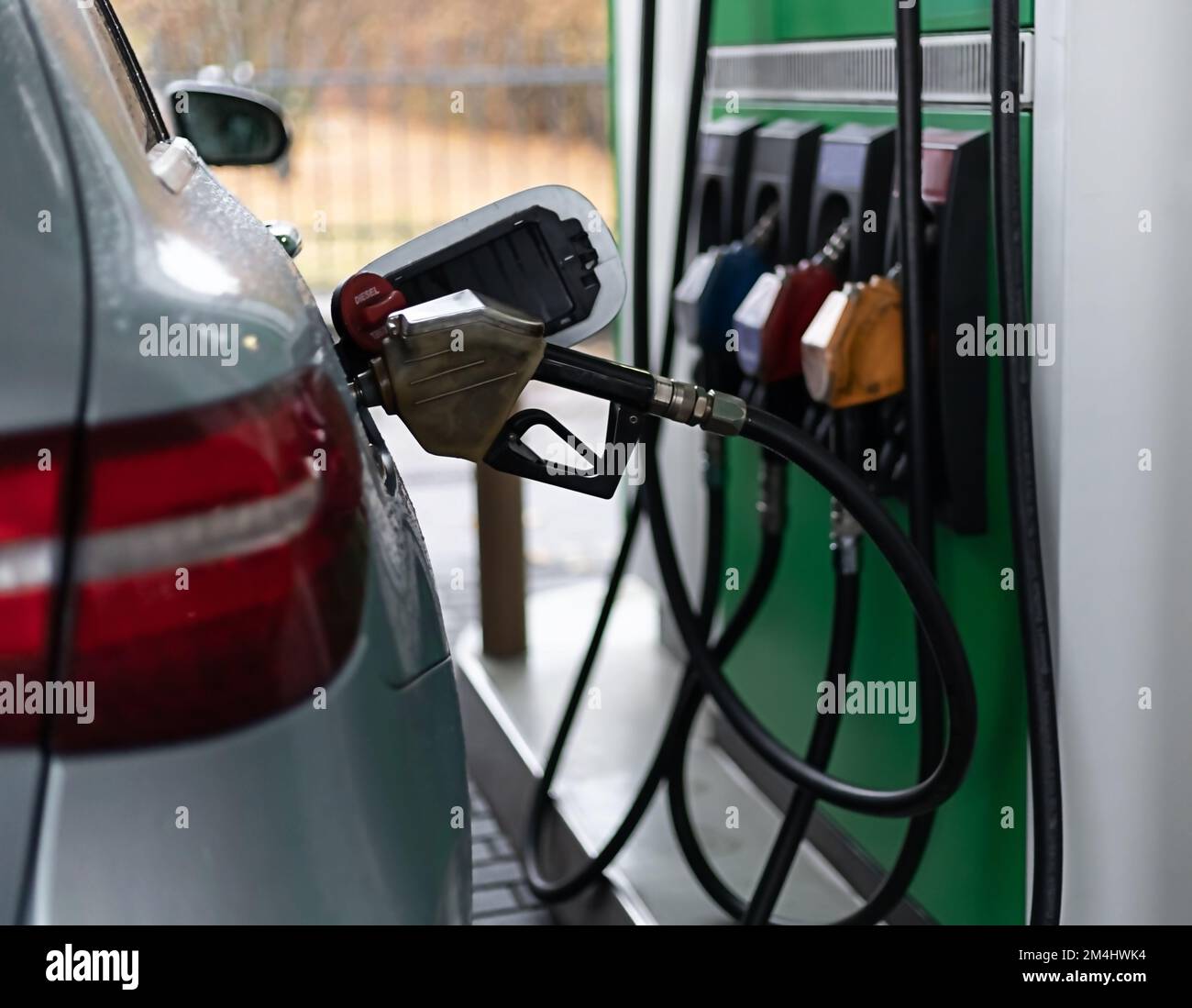 Close up of diesel and petrol fuel pistols. Pumping gasoline fuel in ...