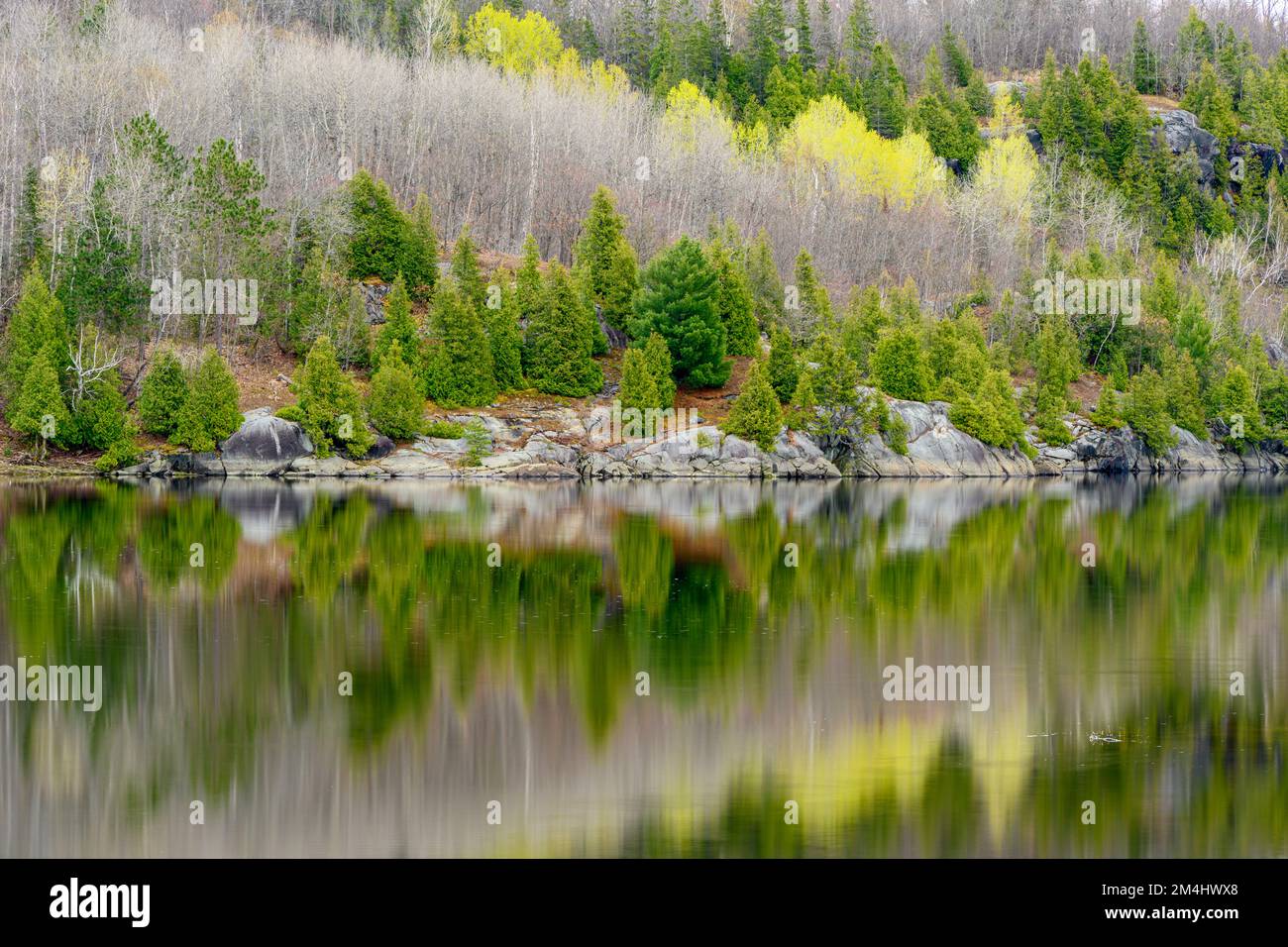 Early spring reflections in Simon Lake, Greater Sudbury, Ontario ...