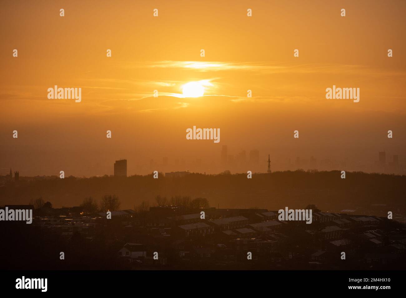 The sun sets over a misty Manchester on the Winter Solstice, Manchester ...