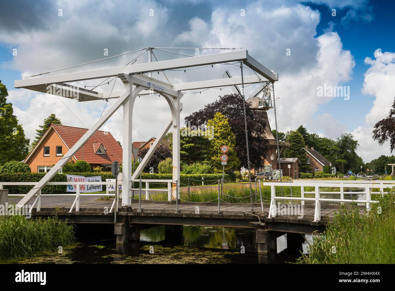 Canal with historic bascule bridge and windmill, Westgrossefehn ...
