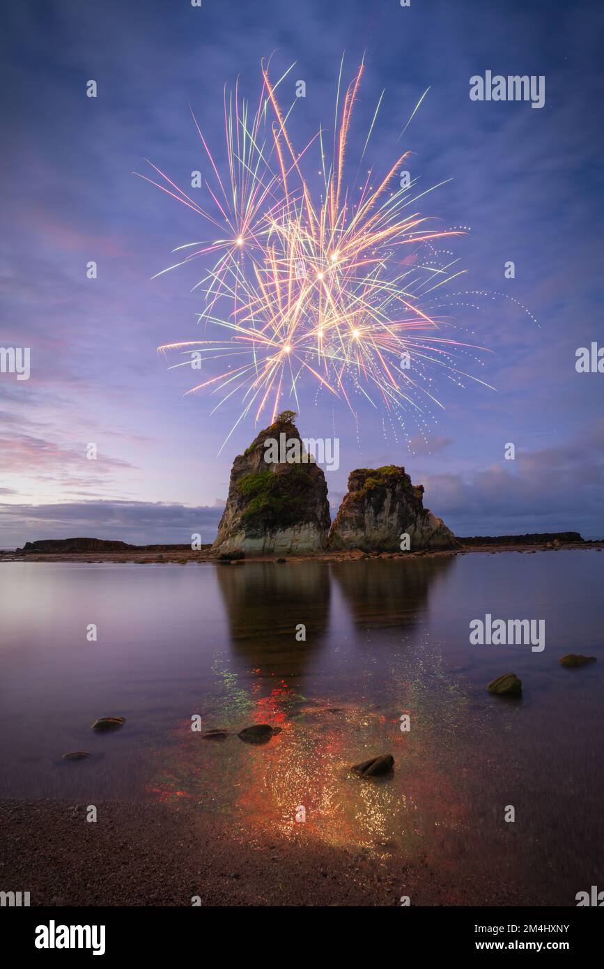 The fireworks above unique rock formations on sandy Tanjung Layar Beach ...