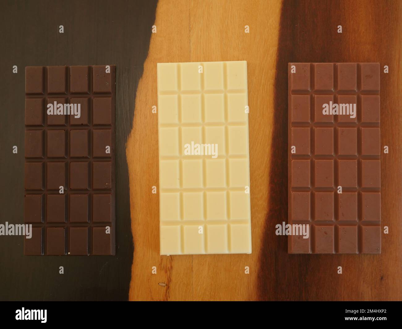 chocolate bars on a wooden table Stock Photo - Alamy