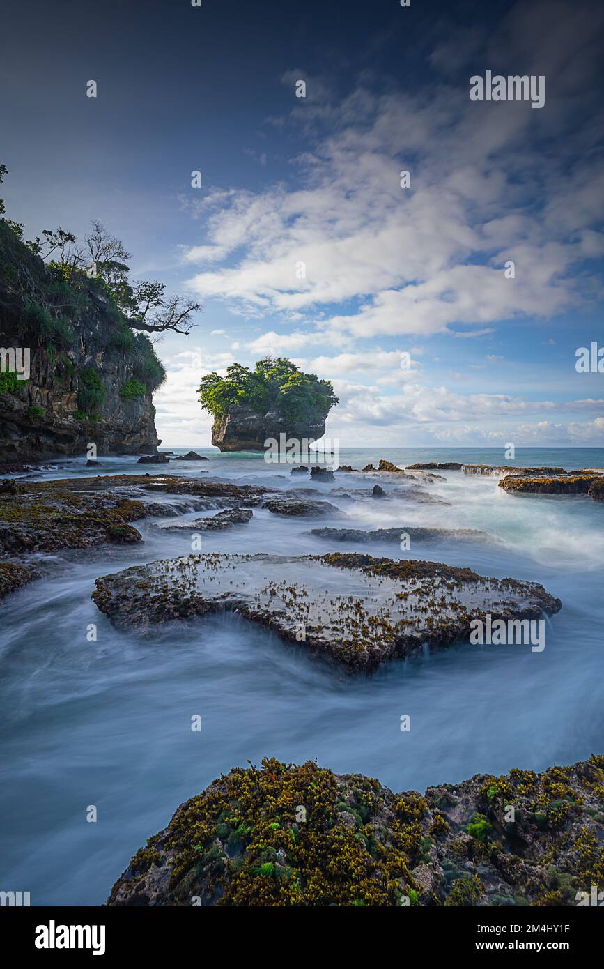 A breathtaking view of Karang Bokor Sawarna in Indonesia under blue cloudy sky Stock Photo - Alamy