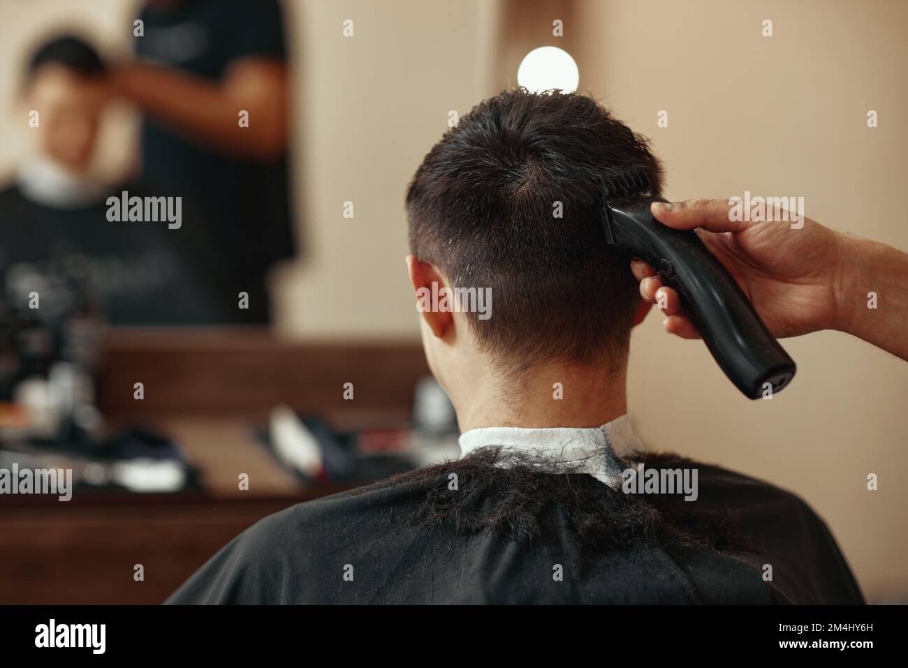 Barber shaving caucasian man in barber shop Stock Photo - Alamy