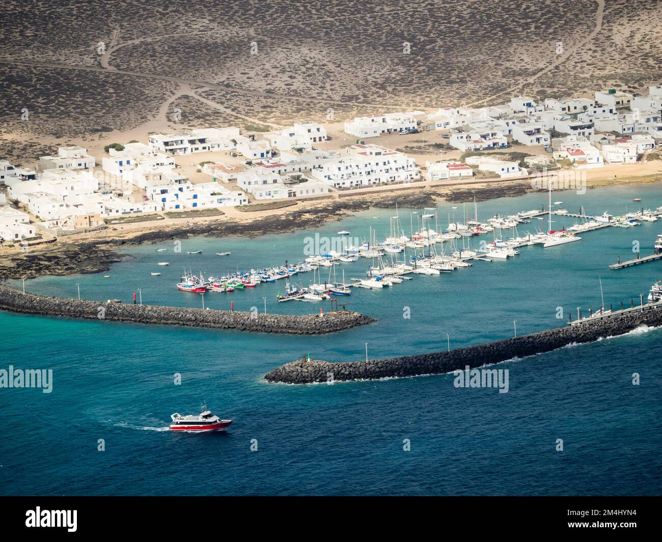 Ferry boat leaving Caleta del Sebo, Island of La Graciosa, viewed from ...