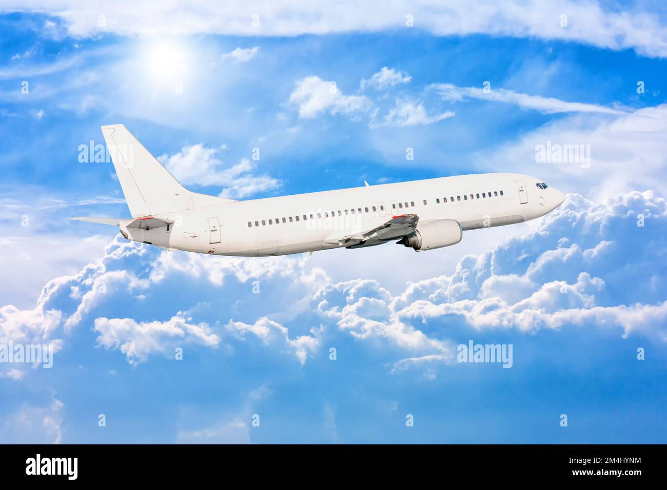 White passenger aircraft fly in the picturesque sky Stock Photo - Alamy