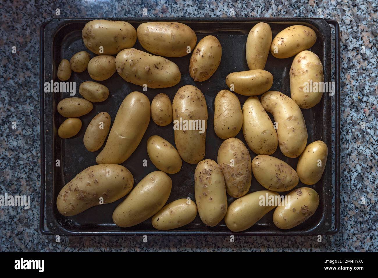 Raw potatoes on a baking tray, Lower Saxony, Germany Stock Photo - Alamy