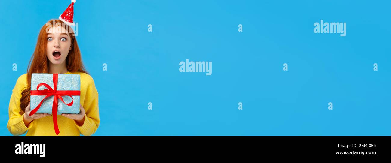 Surprised startled pretty redhead girl receive unexpected gift for ...