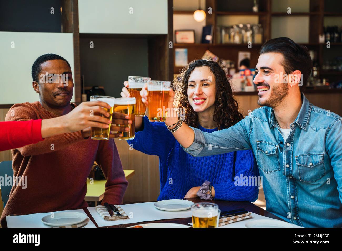 Diverse team worker in a celebration mood toasting glasses. Smiling and ...