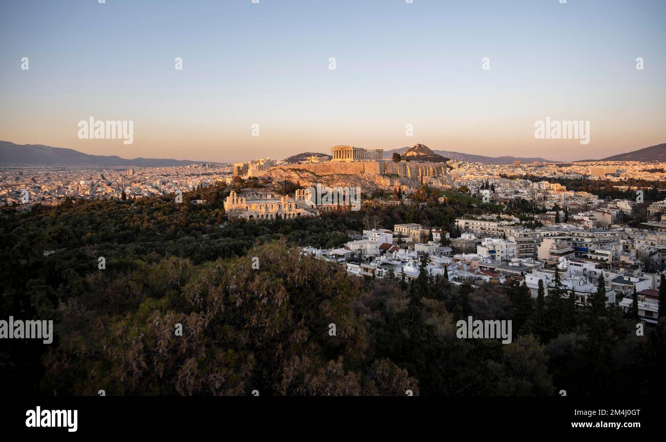 View from Philopappos Hill over the city at sunset, panorama of the Parthenon Temple and Herod's ...
