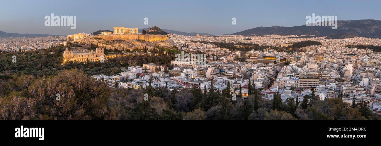 View from Philopappos Hill over the city at sunset, panorama of the illuminated Parthenon Temple ...