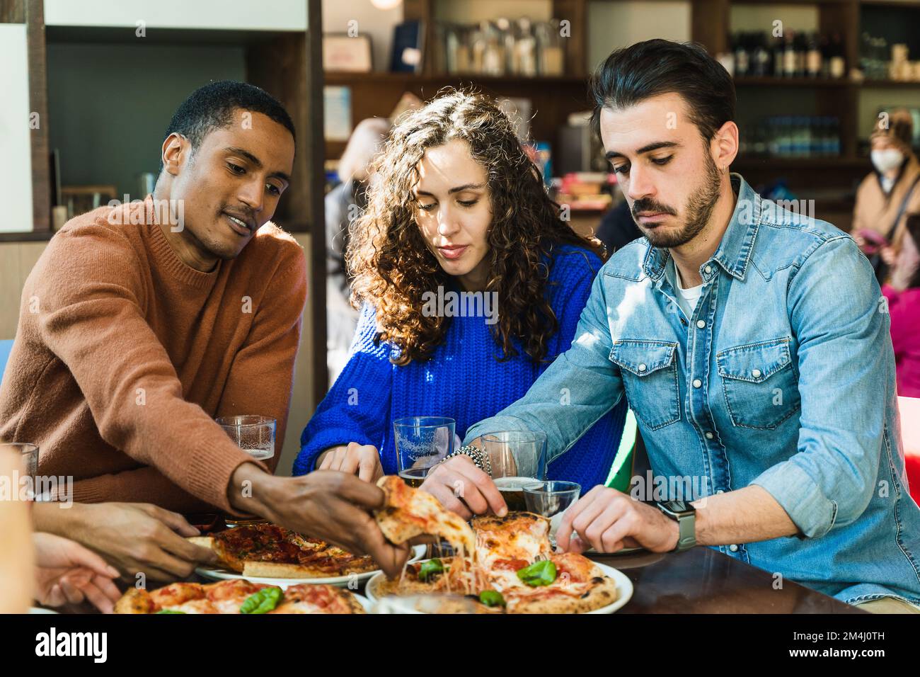 Diverse Team Worker Having Pizza Together In A Cafe African Guy Taking