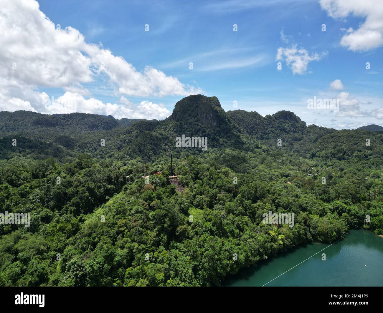 An aerial view of vast forest landscape and Wind Cave Mount At Bau ...