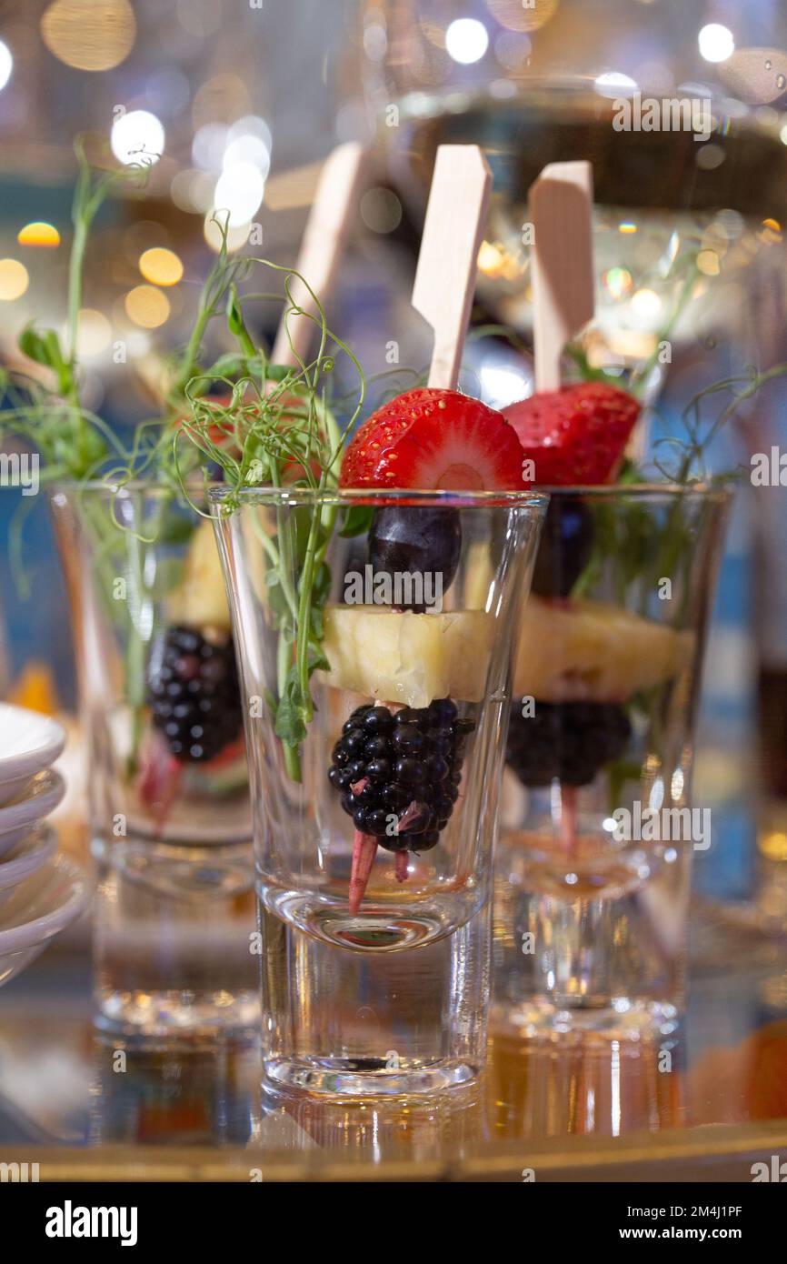snack in a glass glass with berries, cheese and olive Stock Photo - Alamy