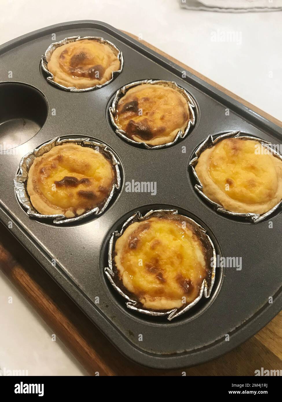 Baking egg tarts in bread mould Stock Photo - Alamy