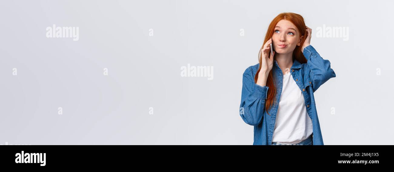 Unsure cute redhead girl troubled give final answer, talking on phone ...