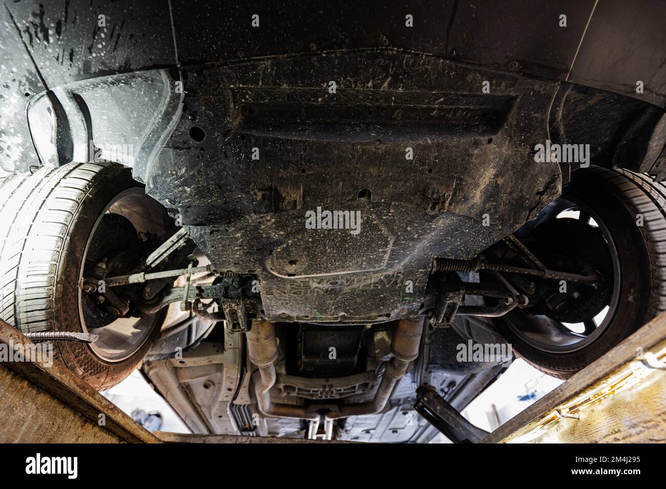 Service repair station working with muscle car. Bottom view of pickup ...