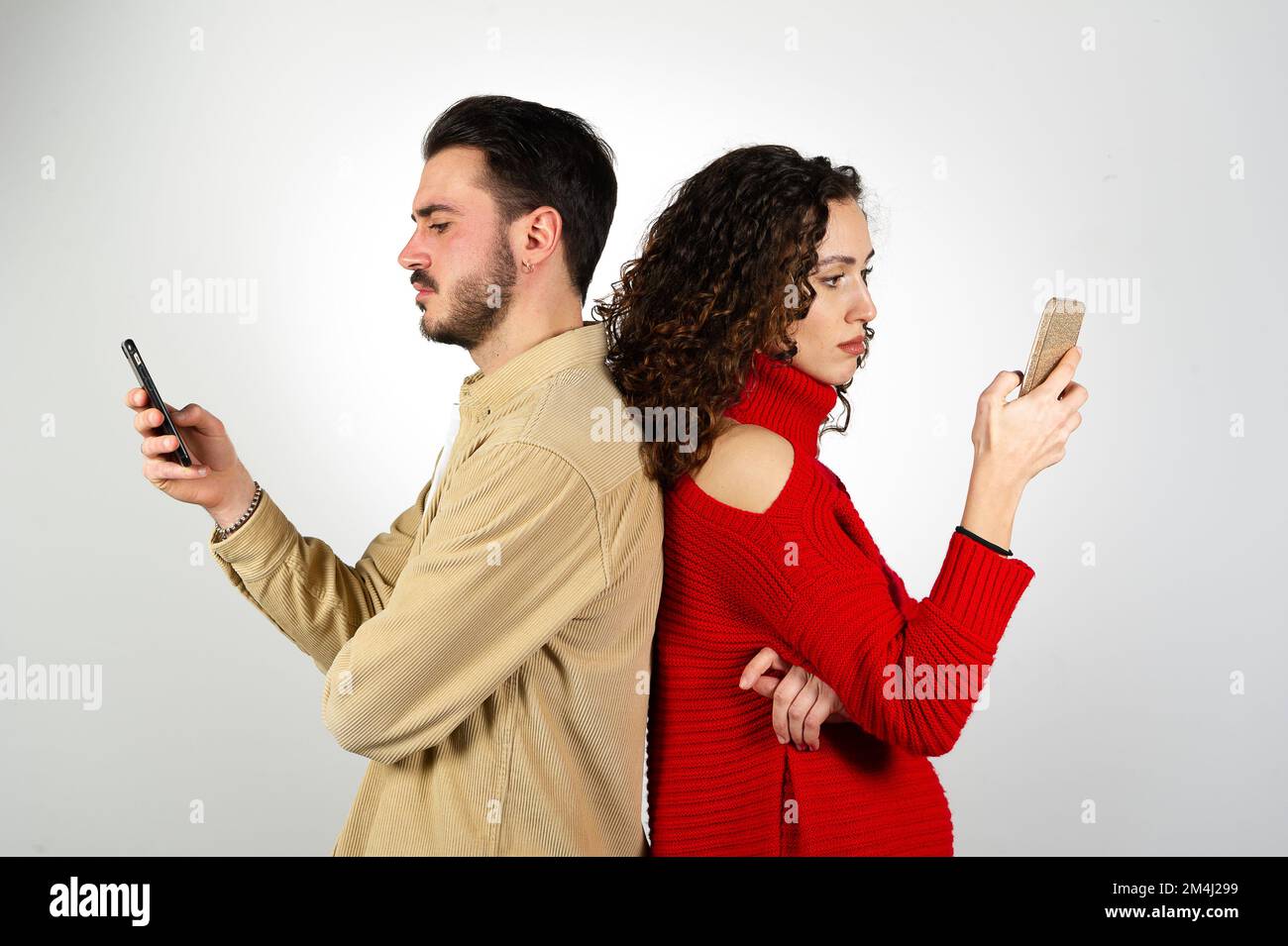 Boyfriends back to back looking concentrates smartphone, isolated on ...