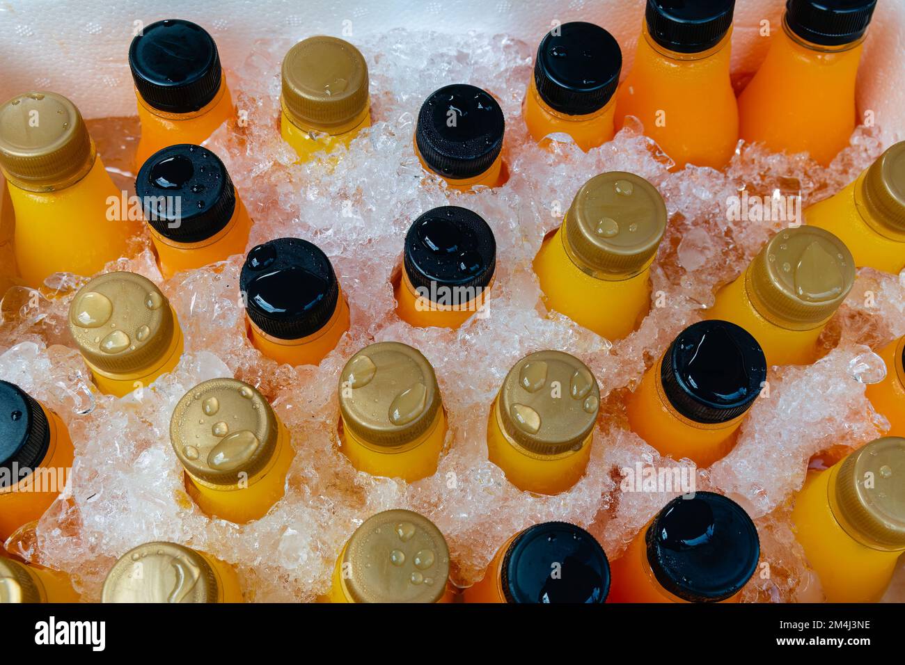 Orange juice or lemonade bottles in a box of ice, close up Stock Photo ...