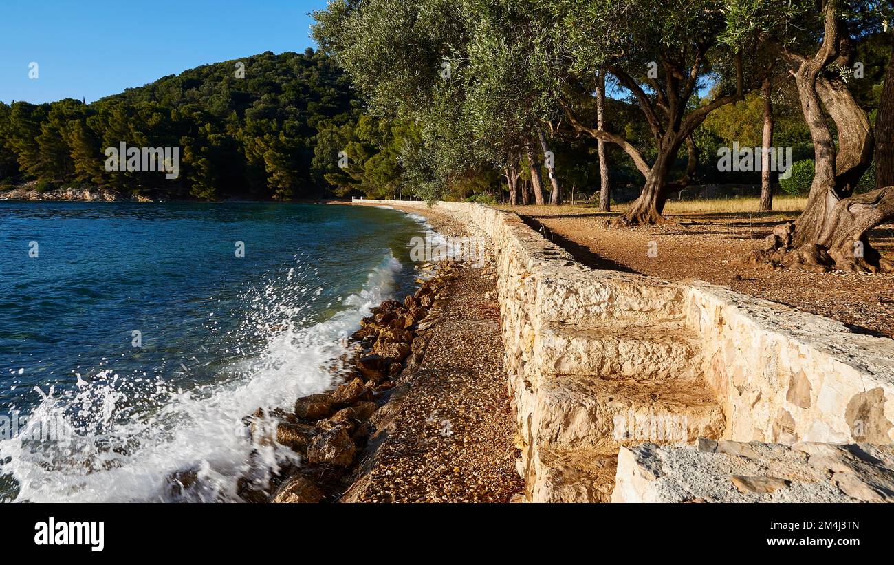 Loutsa Beach, stone wall, surf, trees, Vathi, Ithaca Island, Ionian ...