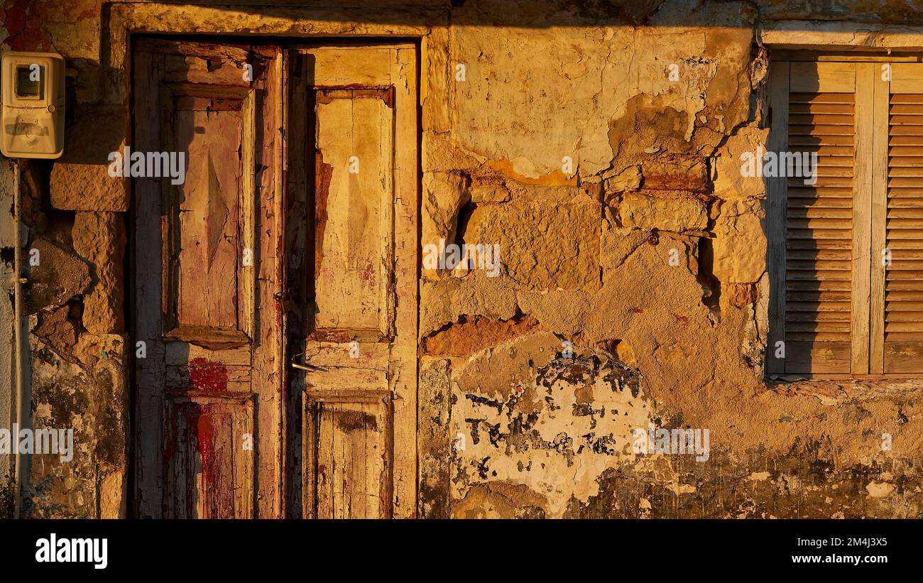 Main village, Vathi, evening light, old house wall, crumbling plaster ...