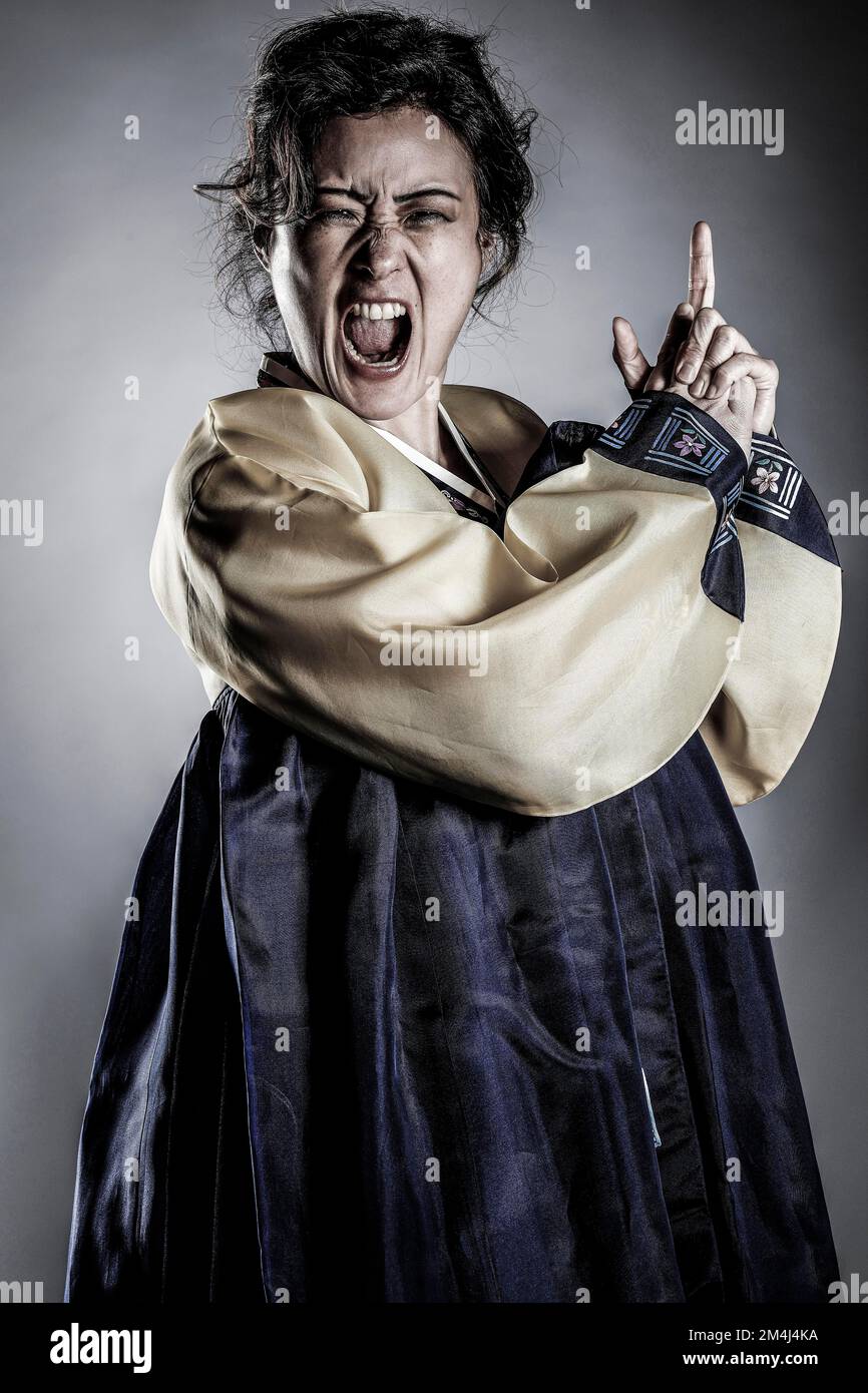 Woman in Korean traditional costume in James Bond pose, Korean woman in ...