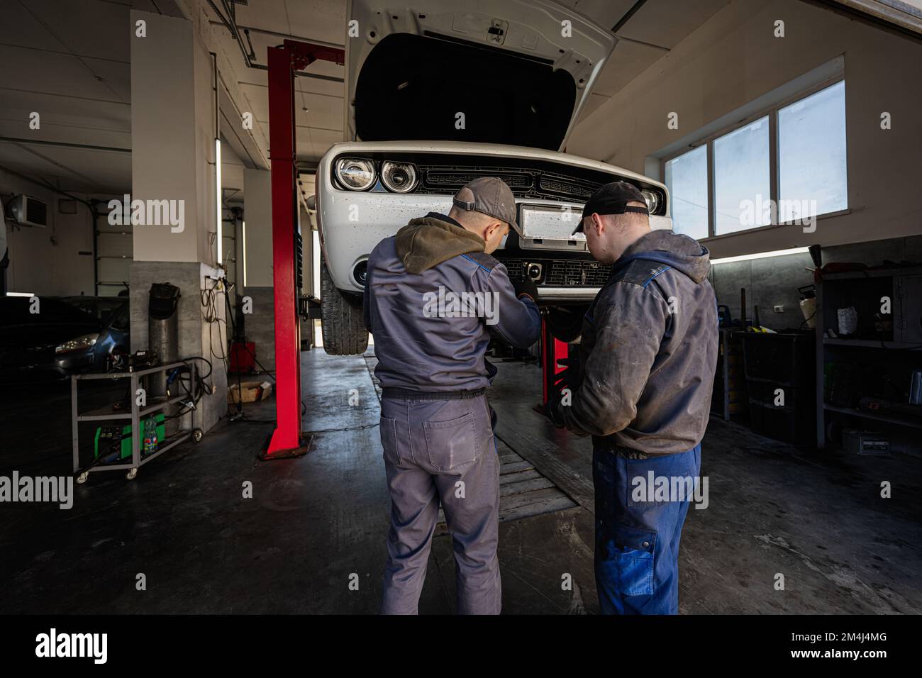 Two mechanic in service repair station calibrate the distronic in ...