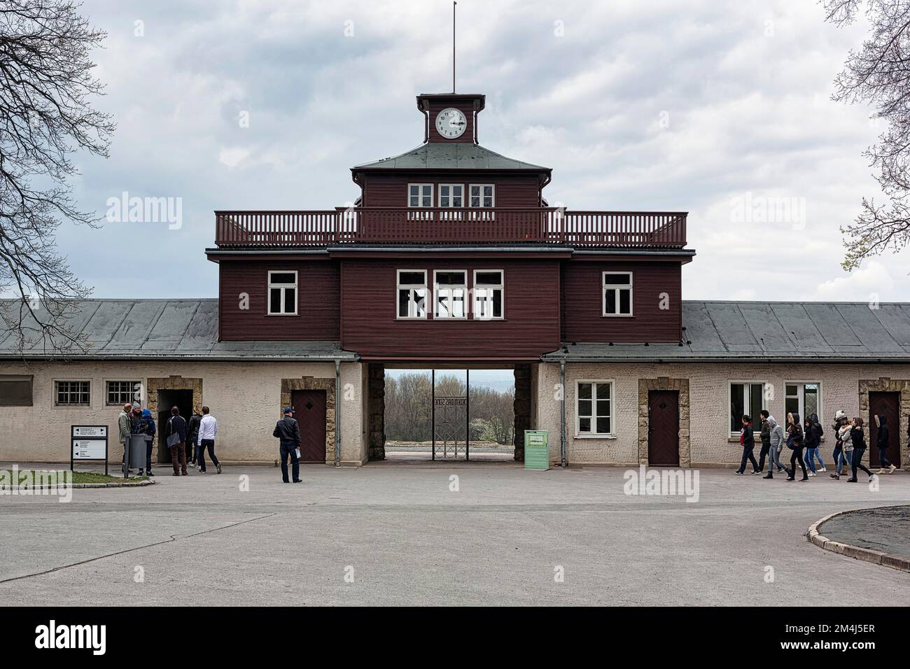 Visitors at the gate to the camp, main watchtower at the former beech ...