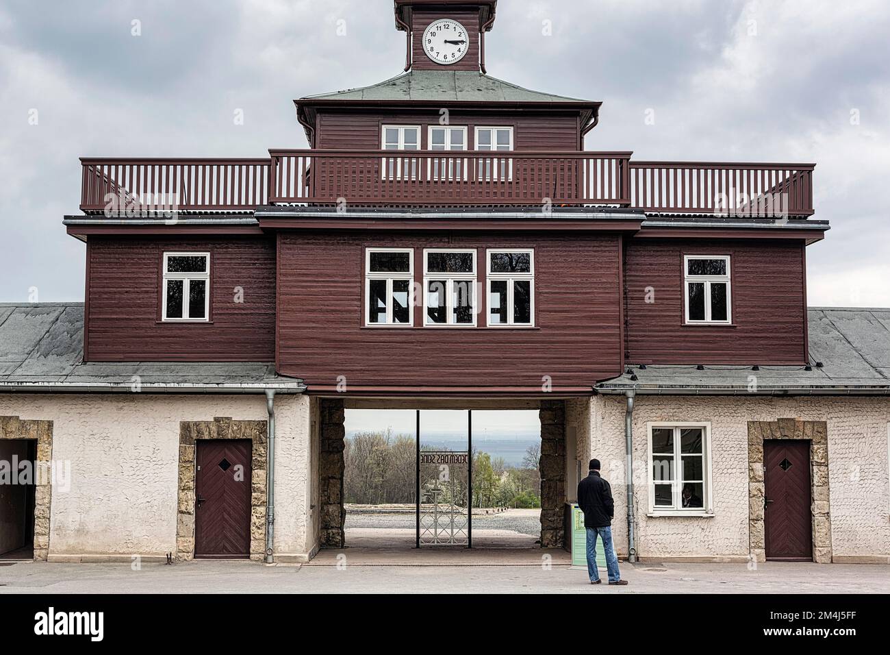 Visitors at the gate to the camp, main watchtower at the former beech ...