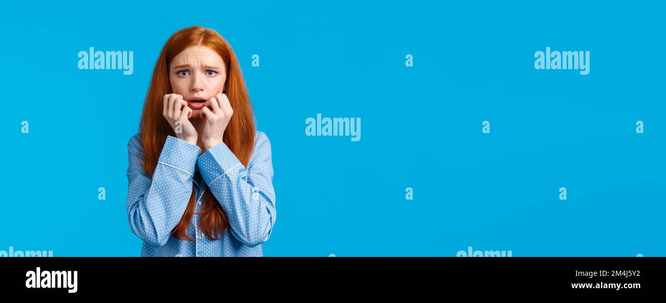 Scared and panicking young worried redhead teenage girl having ...