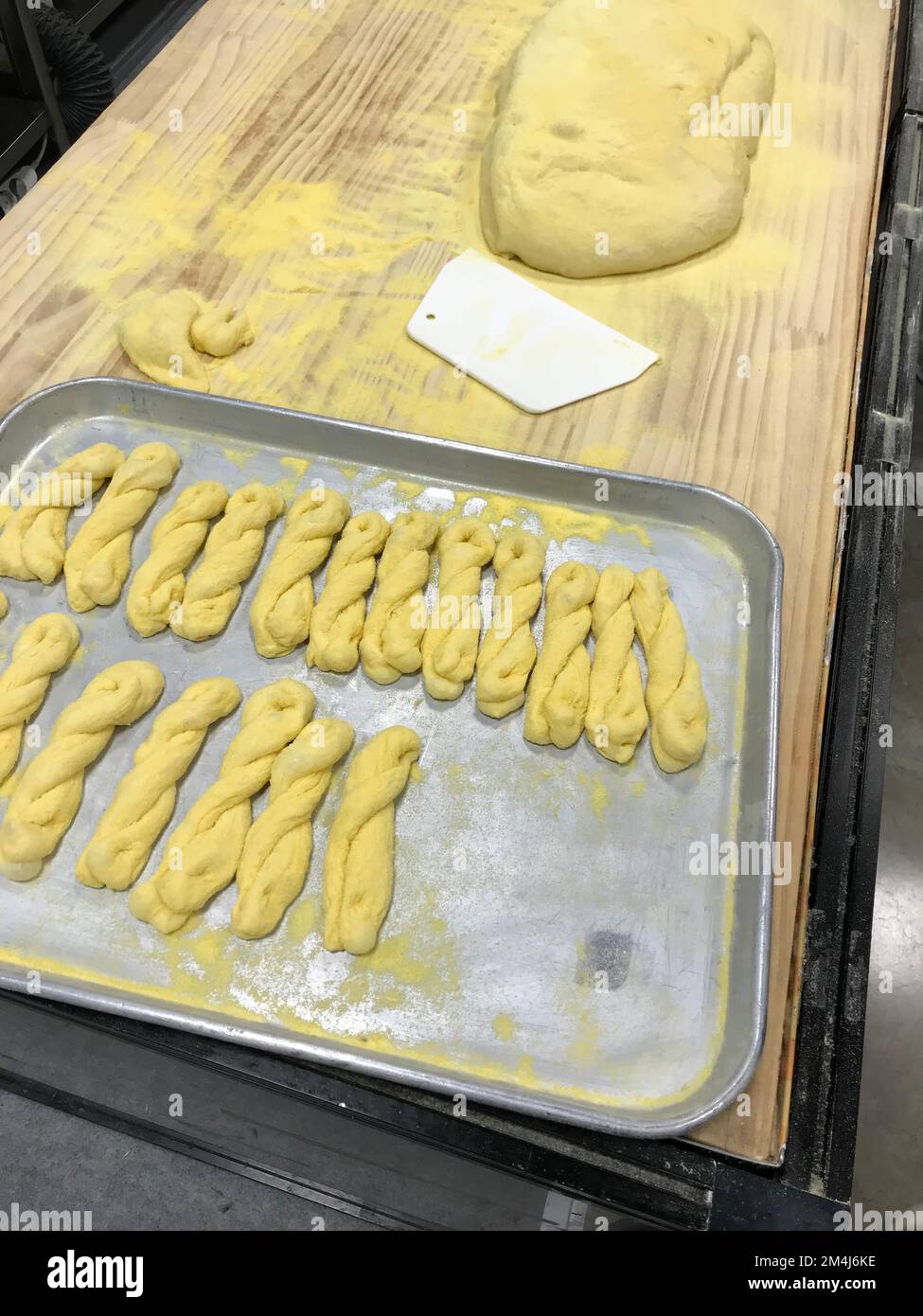 Making Korean Kkwabaegi, the dough of twisted bread stick on the table ...