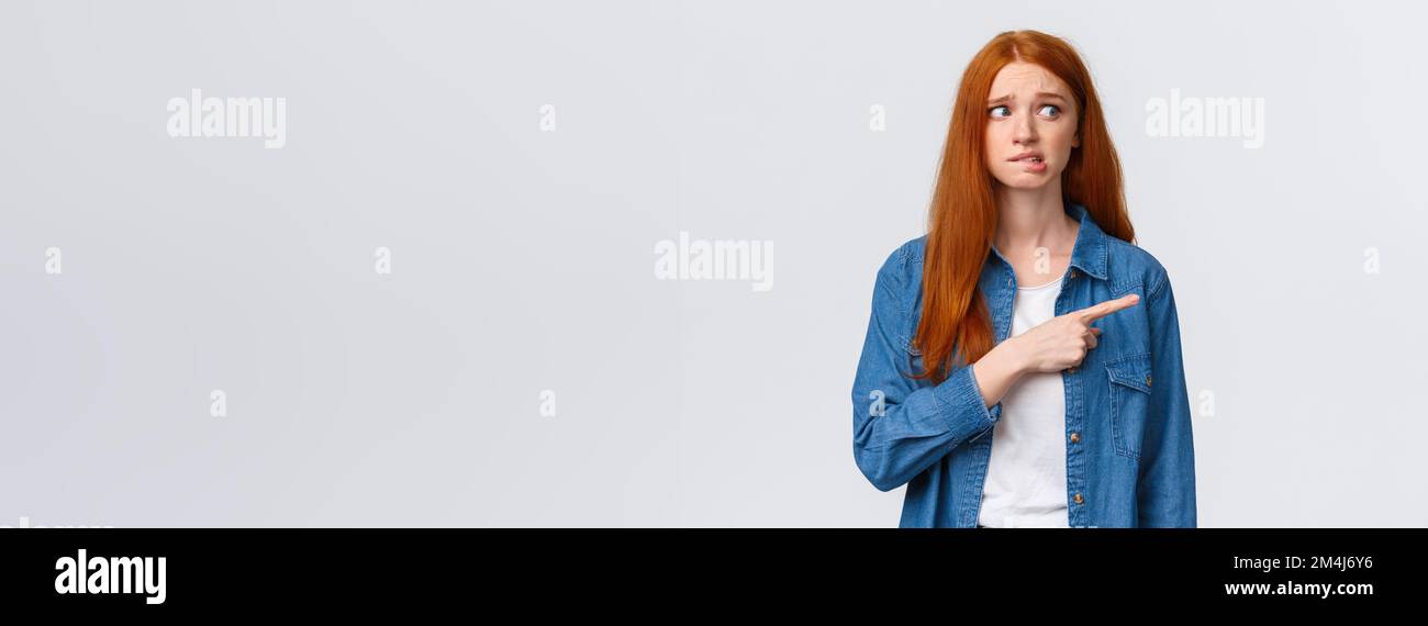 Awkward and nervous cute timid redhead teenage girl having fear or ...