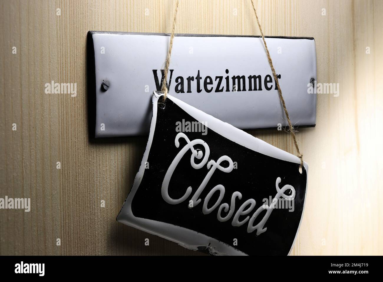 enamel sign on the door to the (closed) waiting room of a German doctor ...