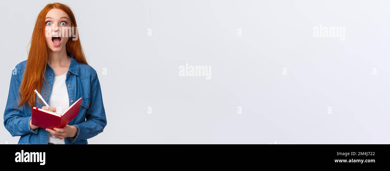 Amused and excited, astonished redhead girl fascinated with amazing ...