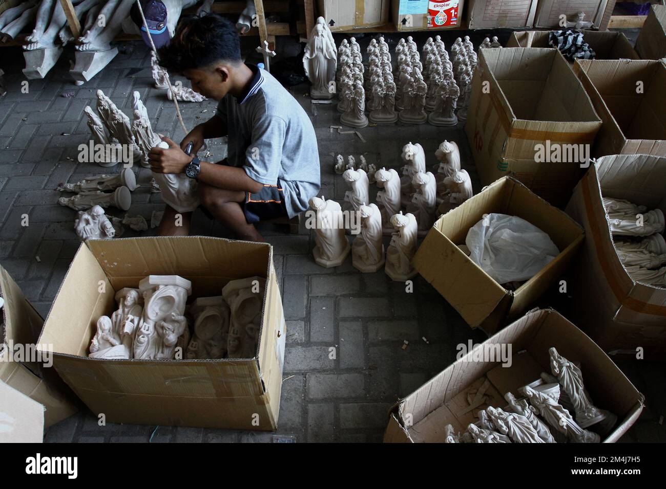 A craftsman makes final touches on spiritual sculpture in Bantul ...