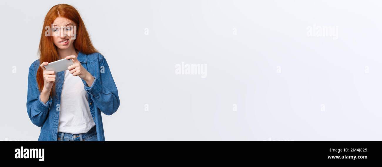 Girl having intense fighting round in game, tap screen and trying beat ...