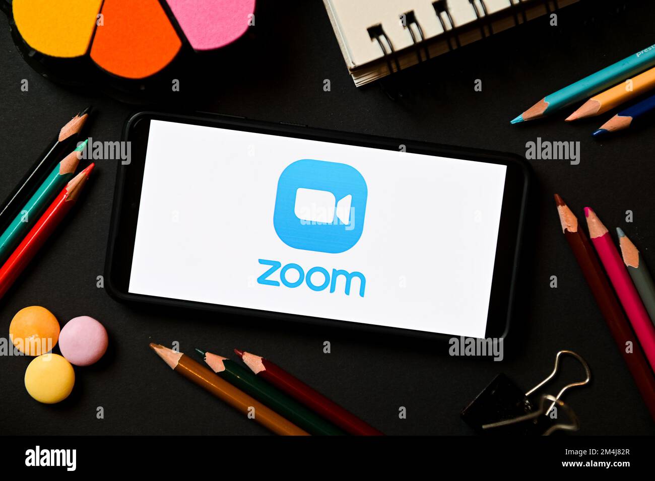 In this photo illustration a Zoom logo seen displayed on a smartphone ...